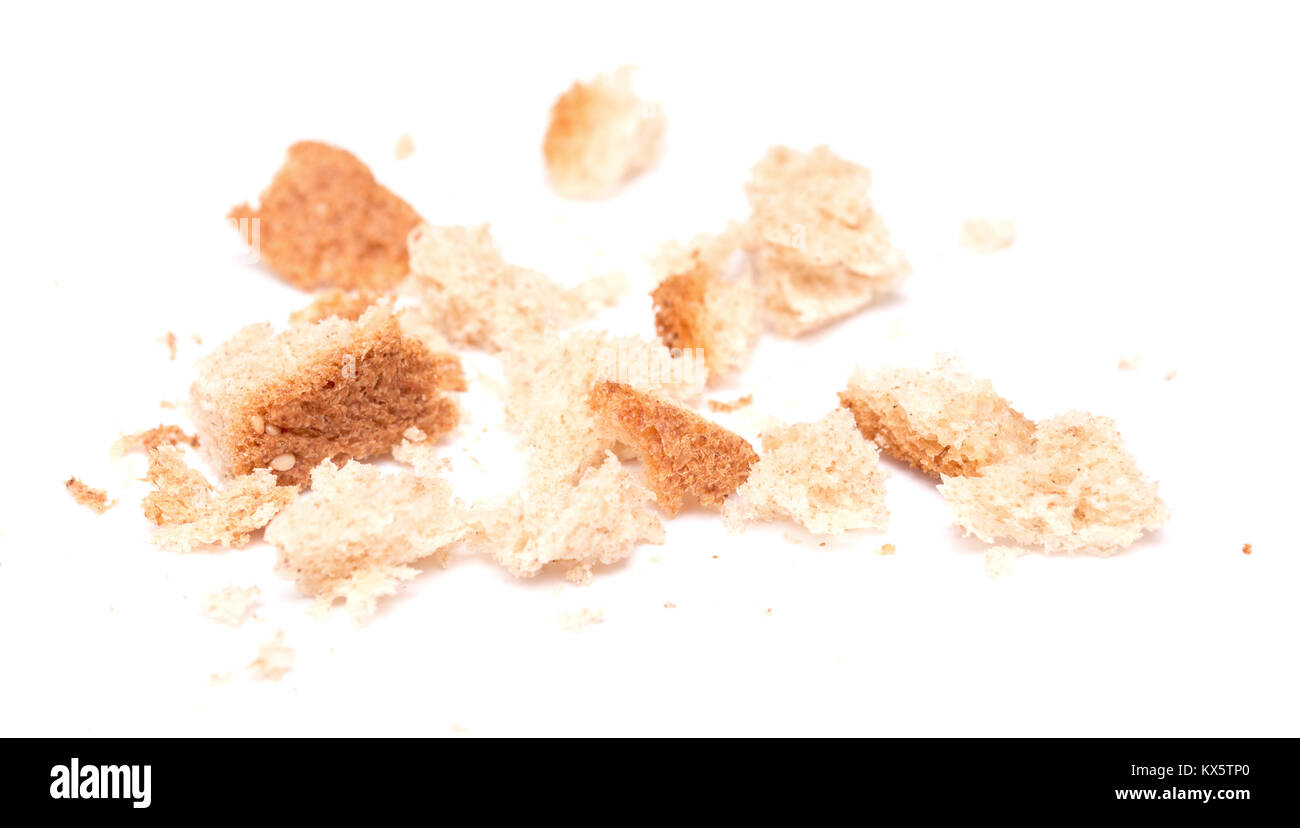 Crumbled pieces of bread on white background Stock Photo - Alamy