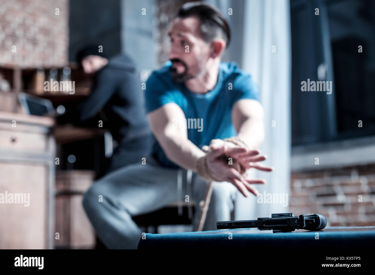Terrified man trying to escape Stock Photo - Alamy
