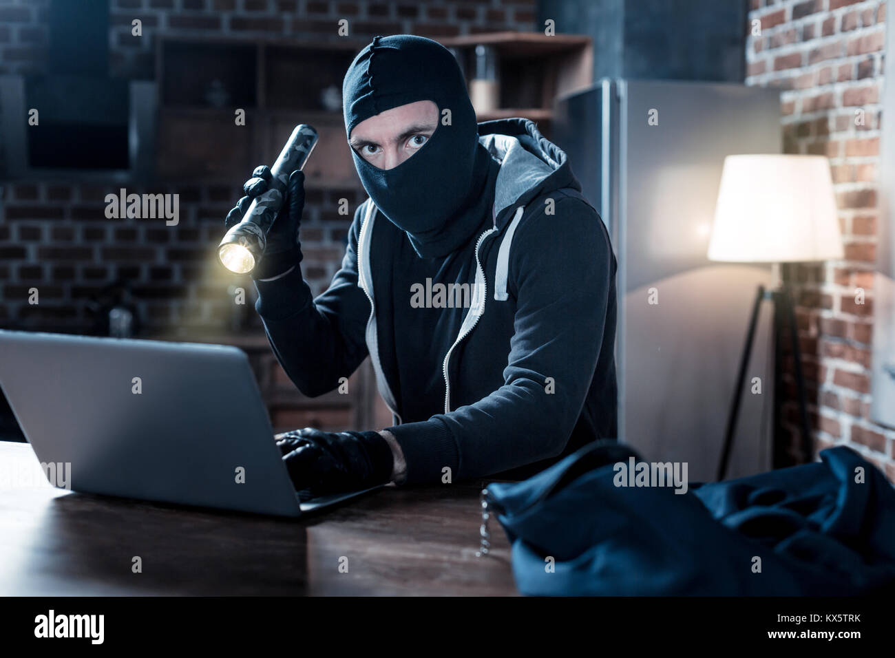 Masked hacker making a cyber attack at night Stock Photo - Alamy