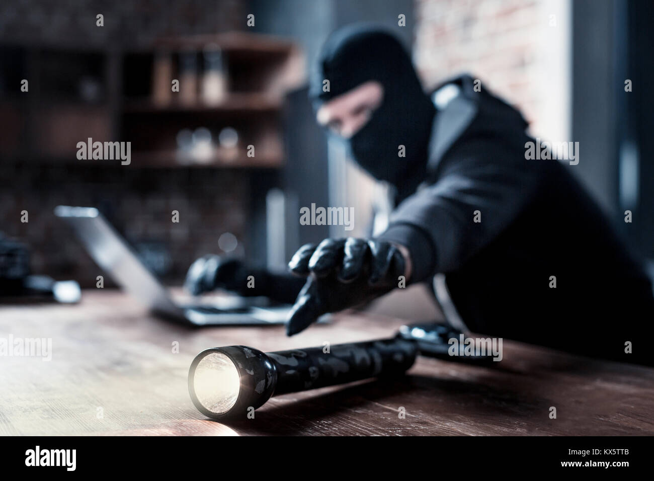 Professional hacker reaching for a torch Stock Photo - Alamy