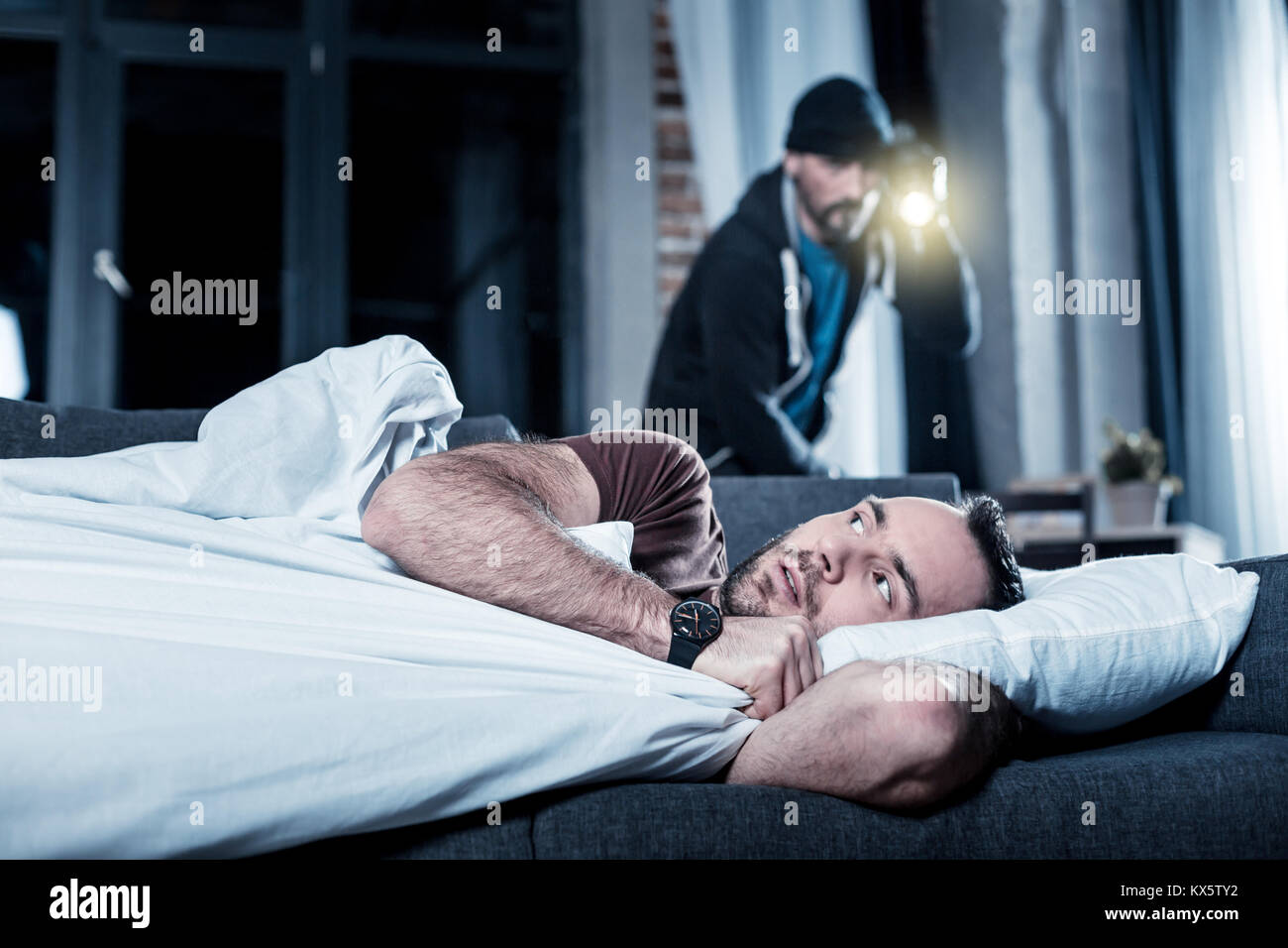 Scared man hearing a criminal behind him Stock Photo - Alamy