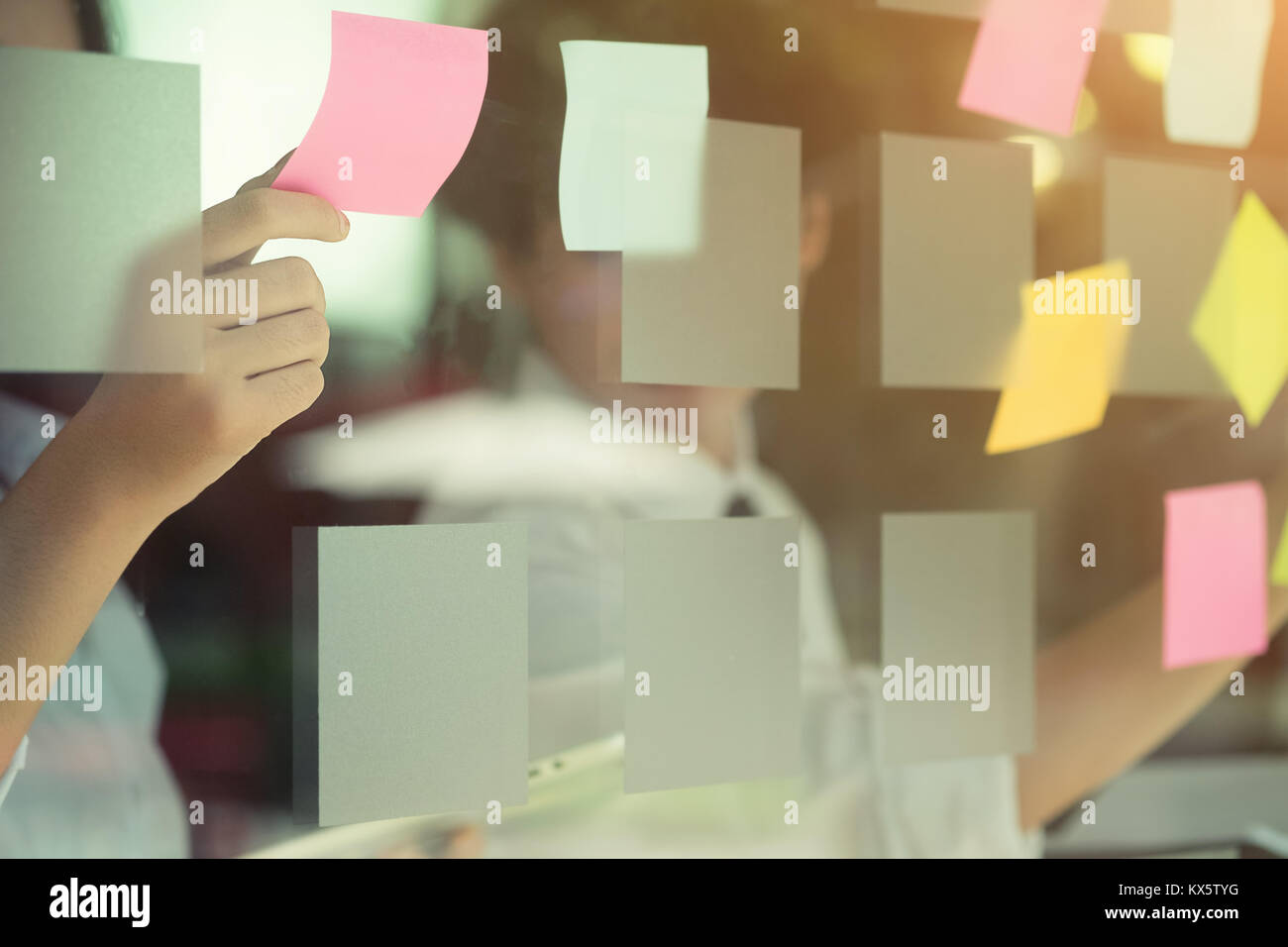 Business meeting Hands using sticky note on windows wall with post it ...