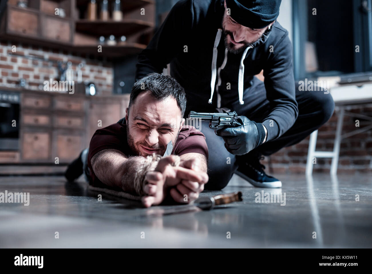 Panic man reaching for a knife Stock Photo - Alamy