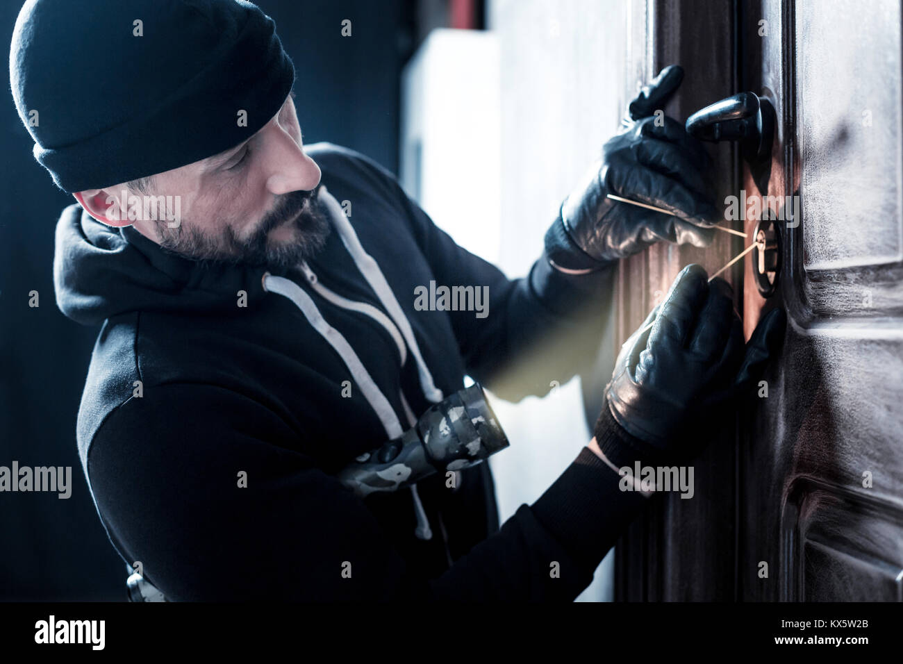Professional burglar breaking into the house Stock Photo - Alamy