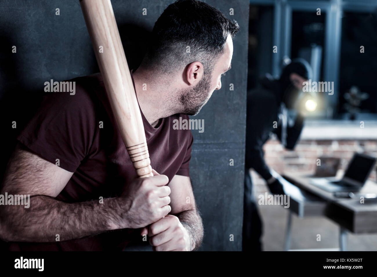 Terrified man hiding from the robber Stock Photo - Alamy