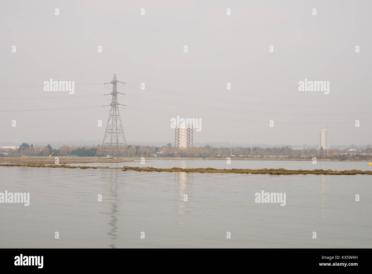 Electrical pylon and hi-rise apartments Stock Photo - Alamy