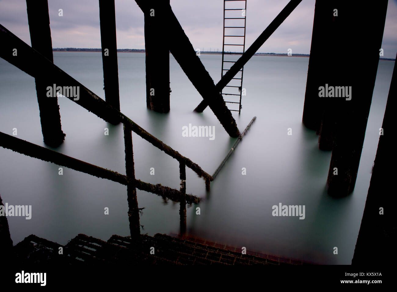 Dark steps and piling in the sea with motion blur and long exposure ...