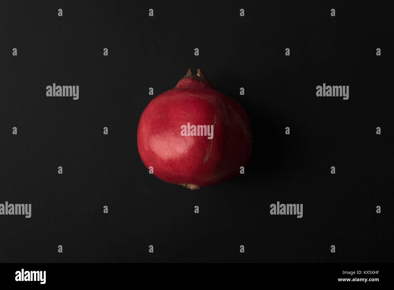 Ripe pomegranate isolated over black background Stock Photo - Alamy