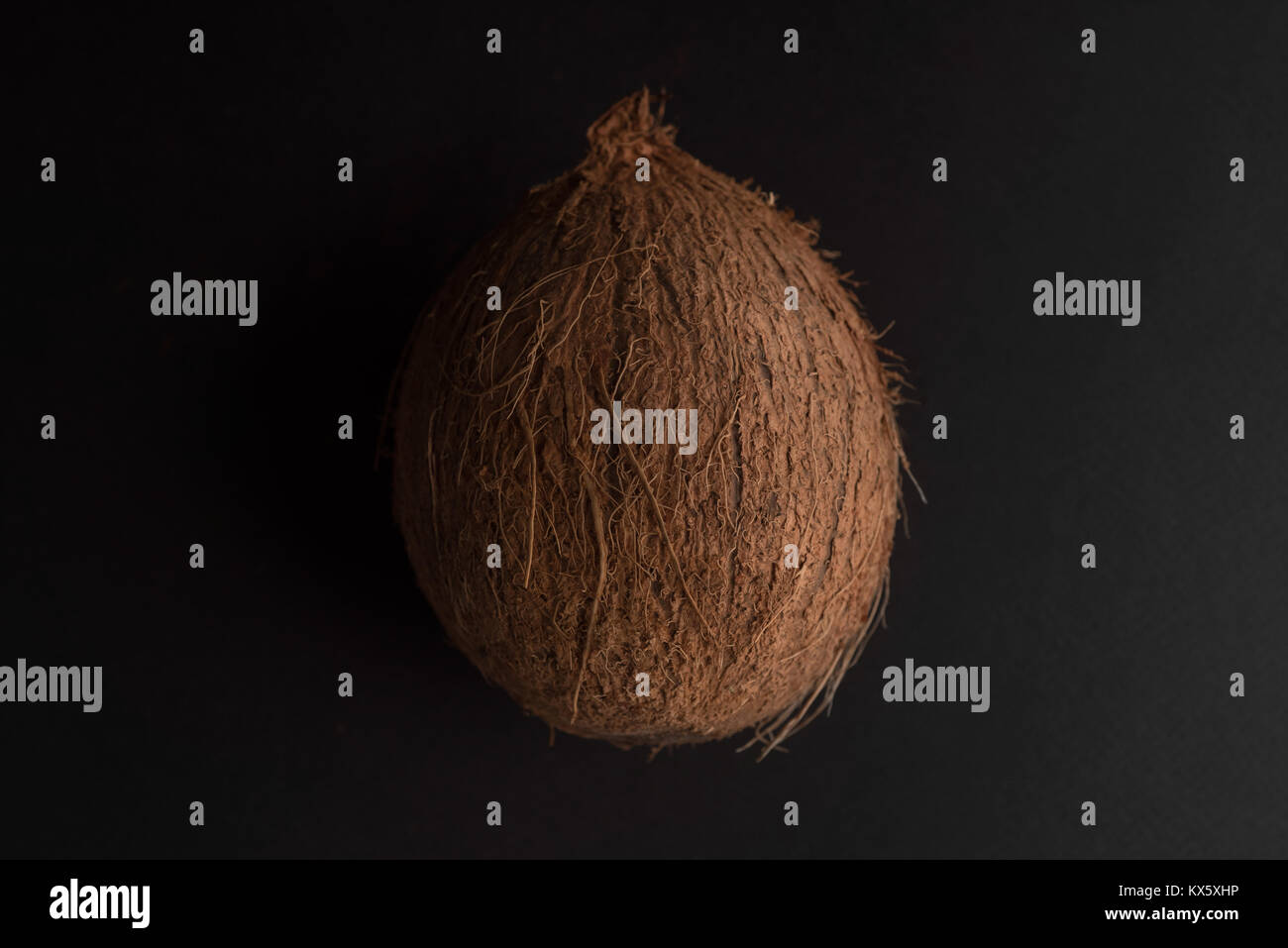 Coconut fruit isolated over black background Stock Photo - Alamy