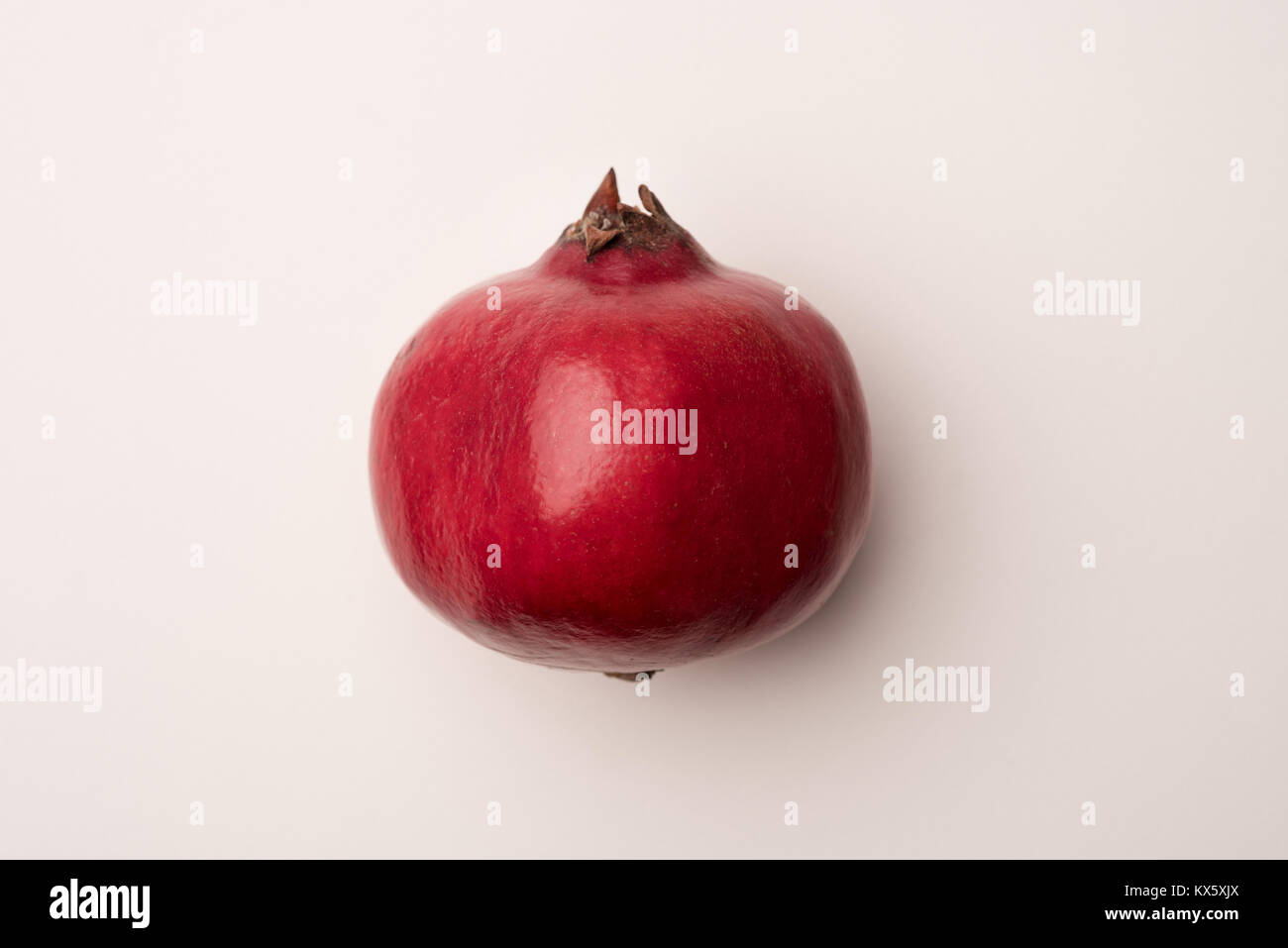 Ripe pomegranate isolated over white background Stock Photo - Alamy