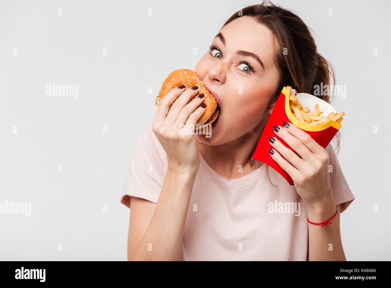 Girl eating french fries hi-res stock photography and images - Alamy