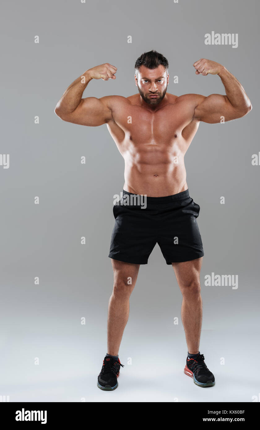 Full length portrait of a muscular concentrated shirtless male ...