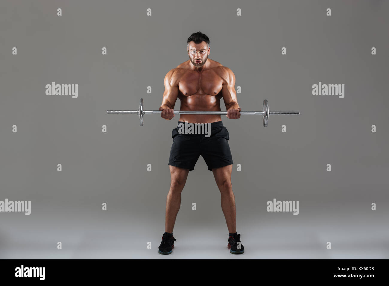Full length portrait of a muscular strong shirtless male bodybuilder ...