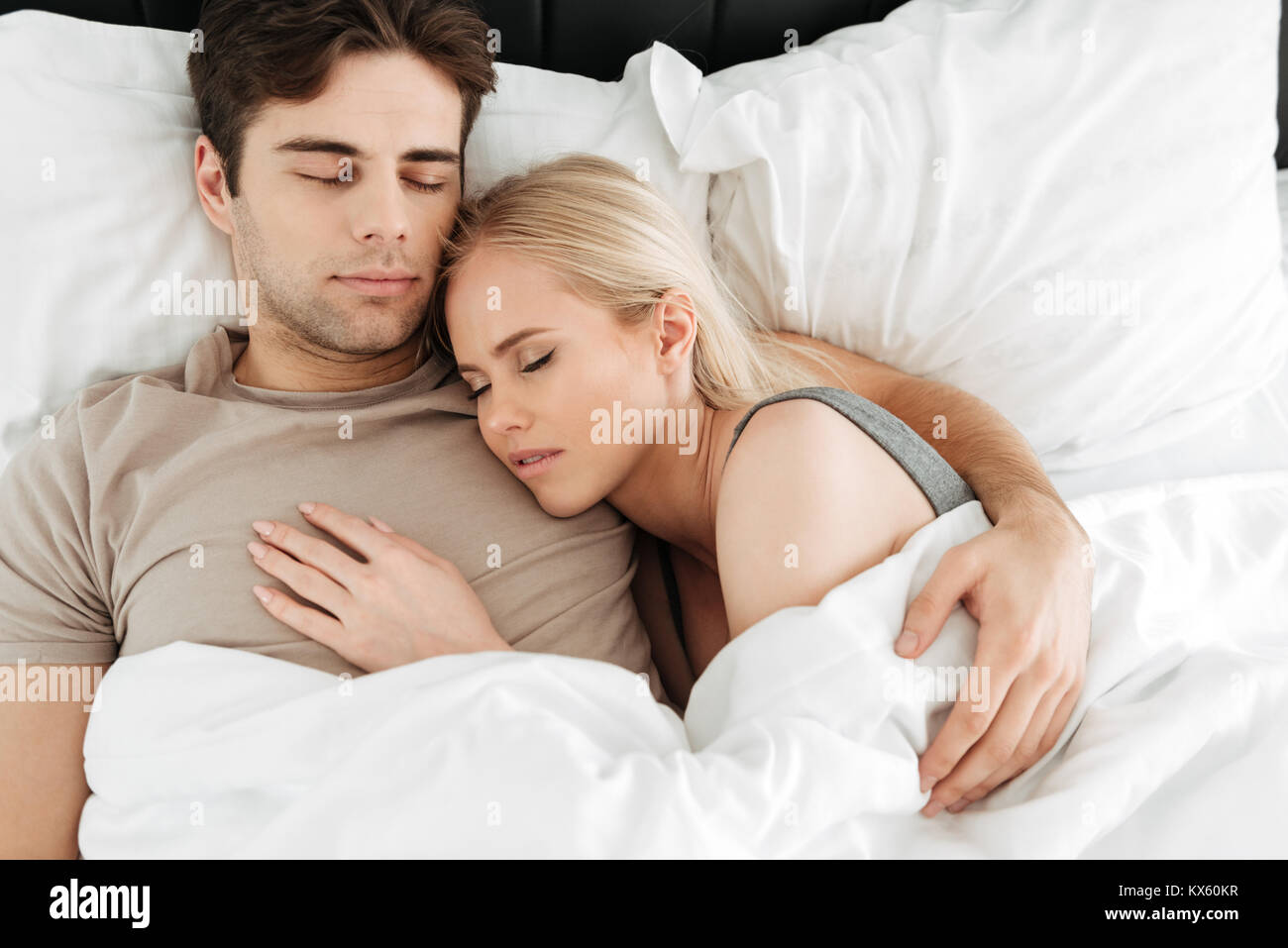 Portrait of calm handsome lovers, young man and woman, sleeping in ...