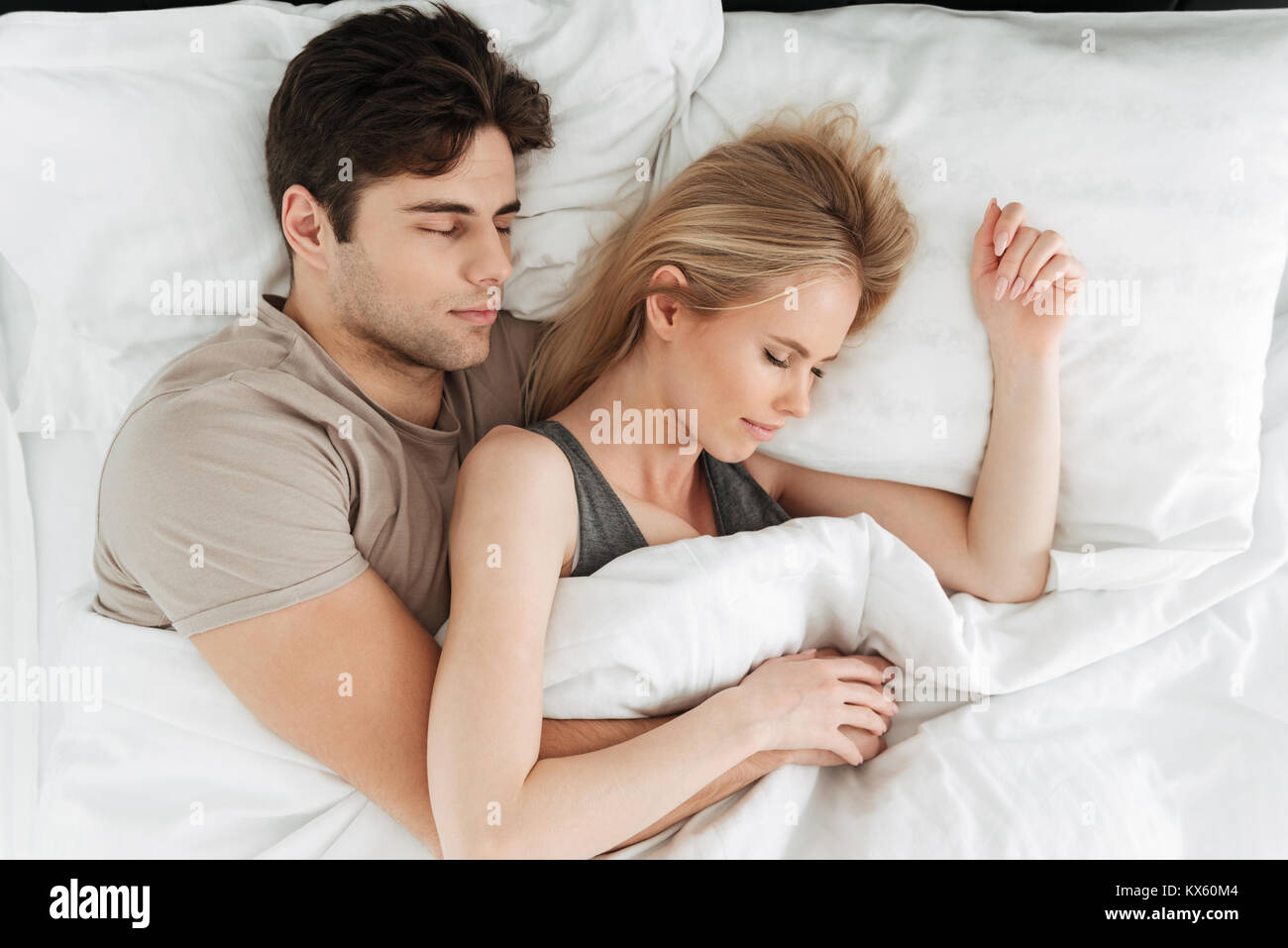 Young lovers sleeping in bed hi-res stock photography and images - Alamy