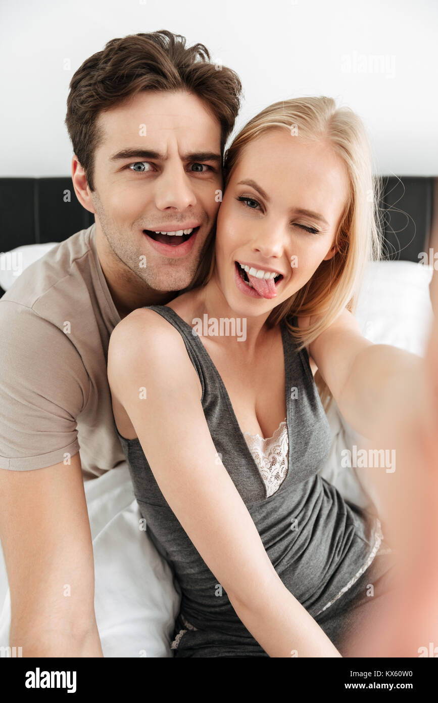Funny Attractive Lovers Making Selfie And Grimacing In The Morning