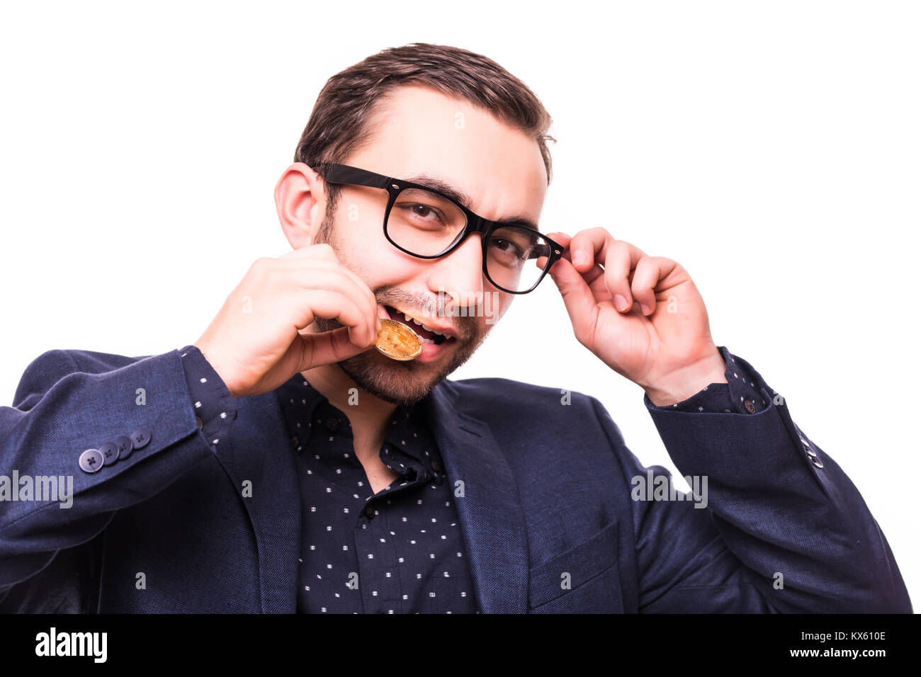 Handsome young man in suit and glasses bite bitcoin cion isolated on ...