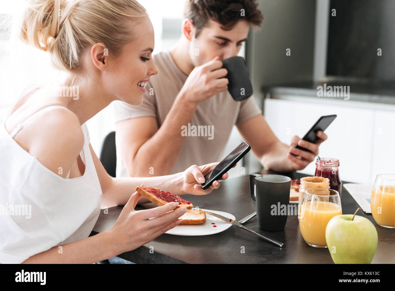 Young family eating fruits breakfast hi-res stock photography and ...
