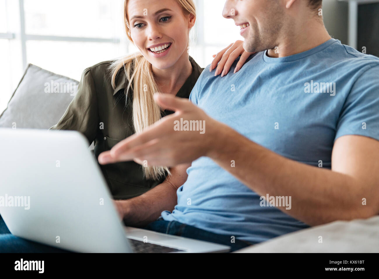 Cropped photo of young lovers using laptop computer and talking in ...