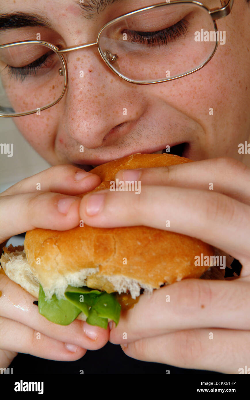 Man eating a hamburger Stock Photo - Alamy