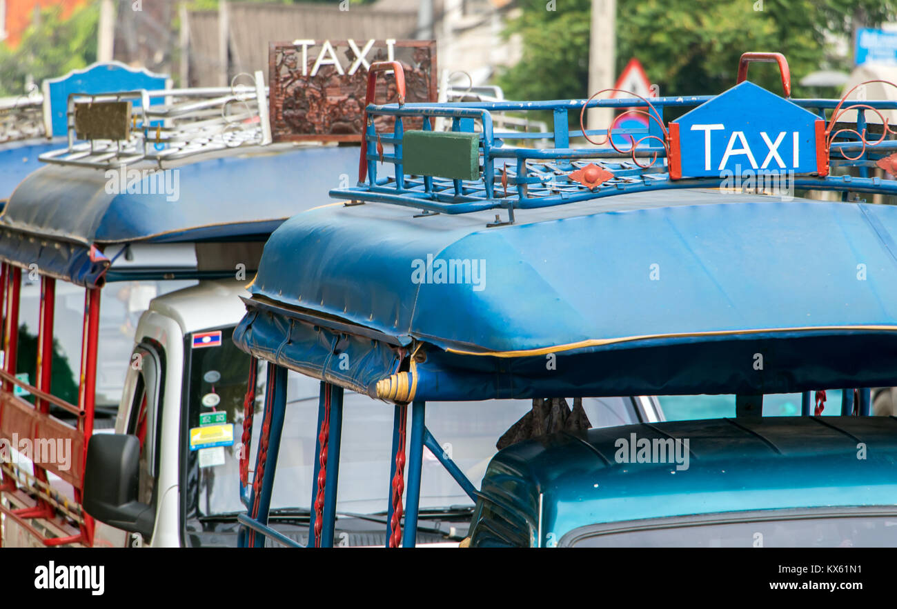 Traditional taxi cars are standing in the street on LuangPrabang city ...