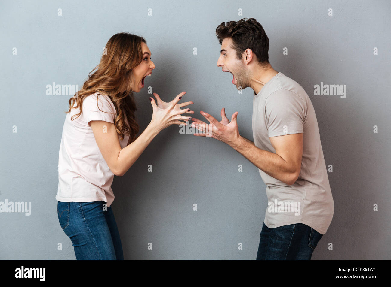 Portrait of a furious young couple having an argument while gesturing ...