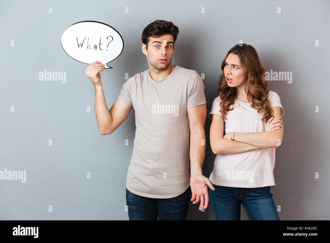 Portrait of a young couple having an argument, frustrated man holding ...