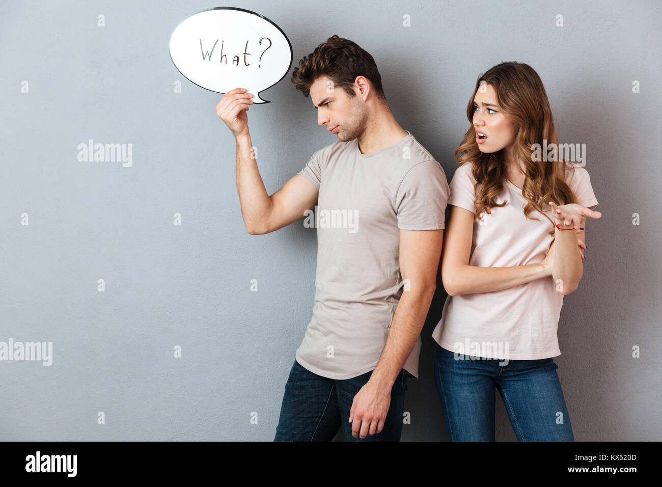 Portrait of a young couple having an argument, frustrated man holding ...