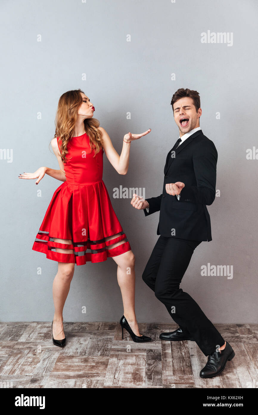 Full length portrait of a happy cheery couple dressed in formal wear ...