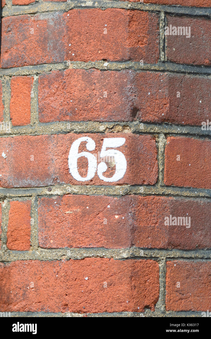 House number 65 sign painted on wall Stock Photo - Alamy