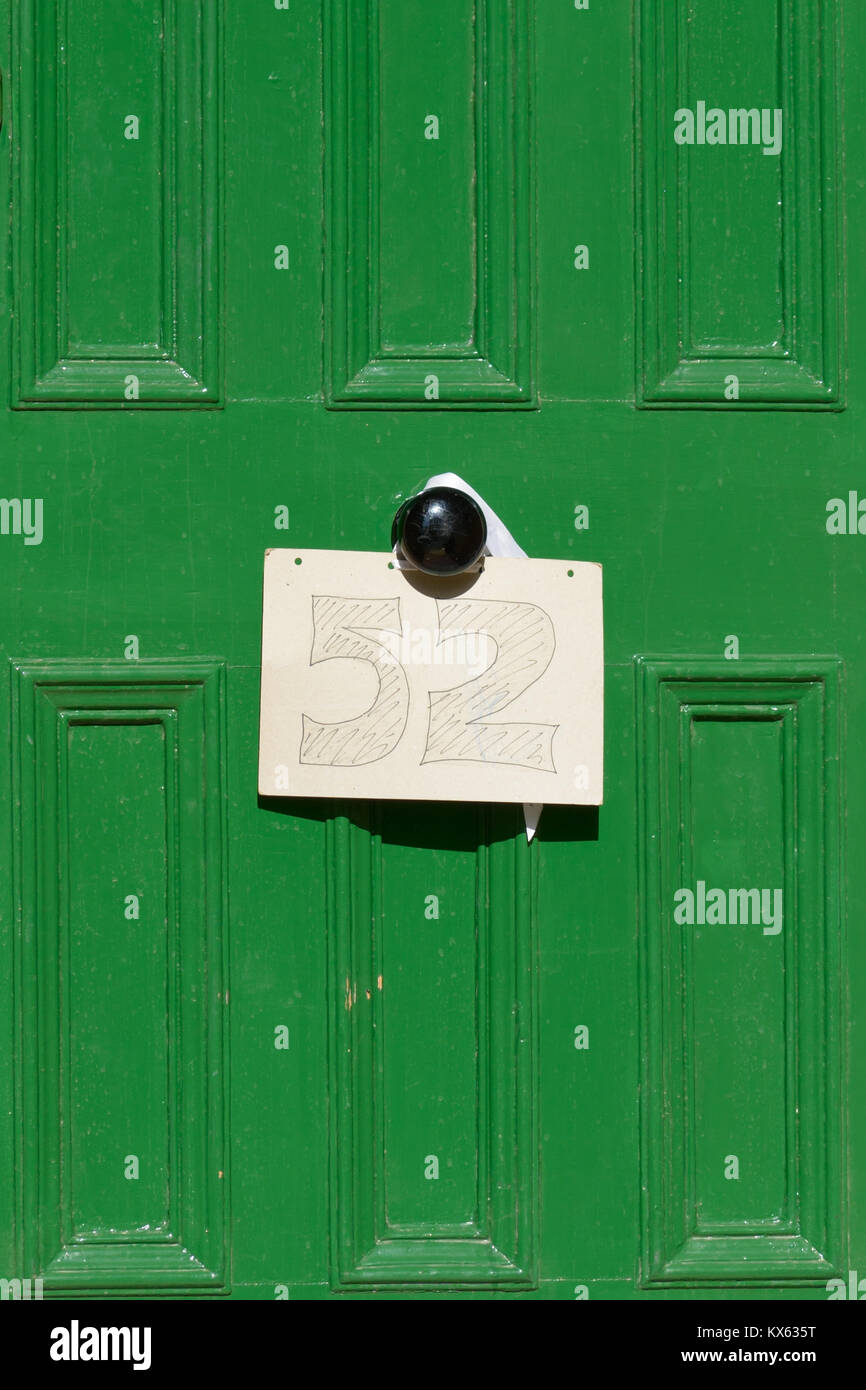 House number 52 sign drawn on cardboard and hanging form door knocker ...