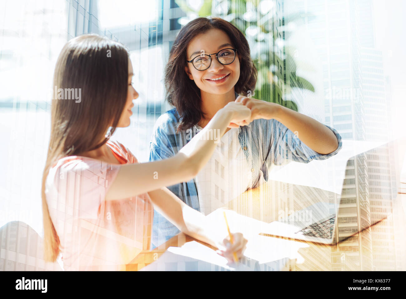 Nice joyful women starting a project together Stock Photo - Alamy