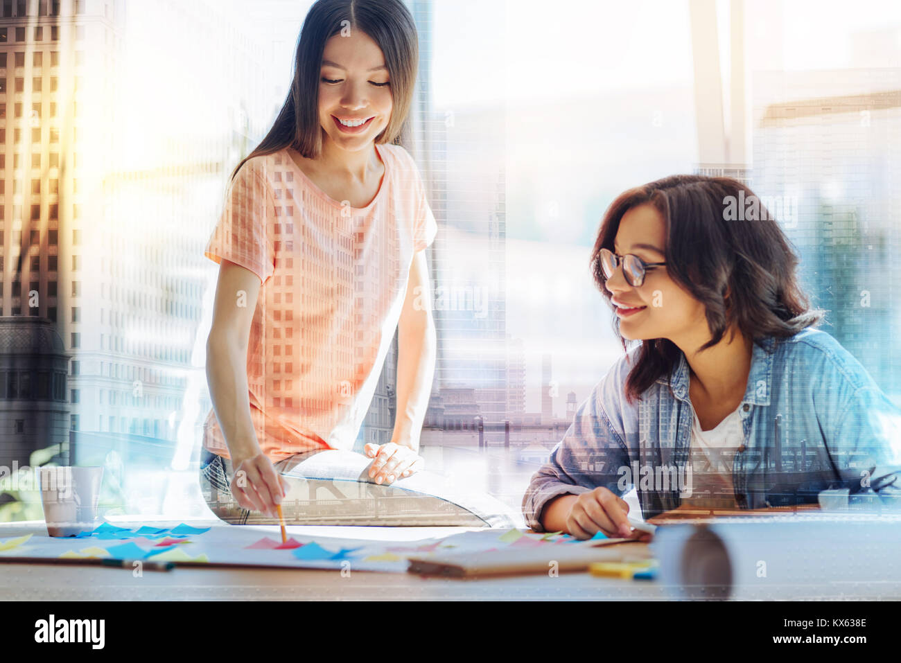 Positive smart students studying together Stock Photo - Alamy