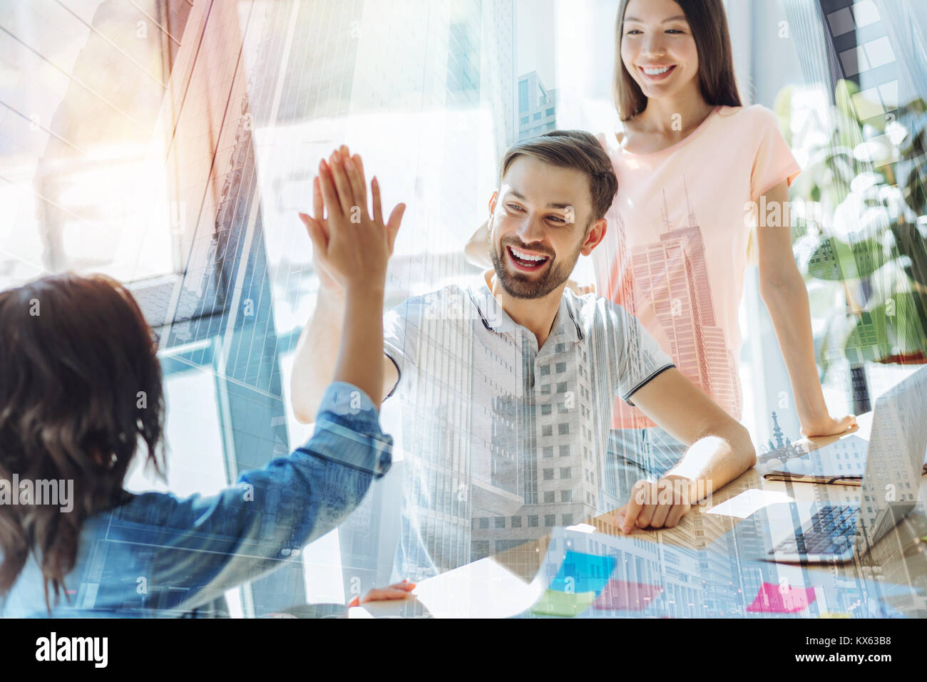 Happy cheerful man giving high five Stock Photo - Alamy