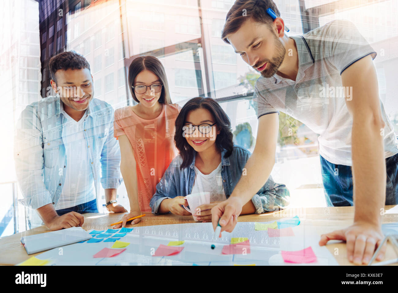 Nice young man pointing at the sticky note Stock Photo - Alamy