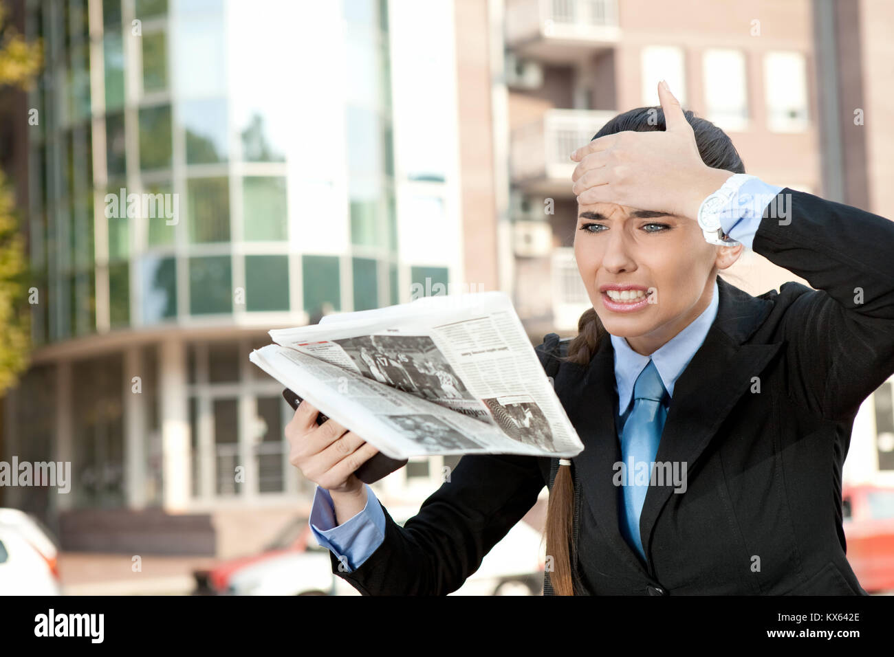 shocked woman reading newspaper on street, oh no bad news Stock Photo ...