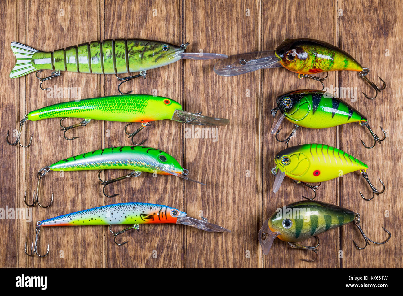 Fishing lures side by side on wooden background Stock Photo - Alamy