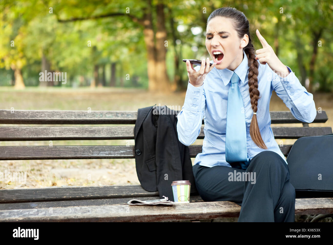 upset businesswoman yelling on mobile phone, outdoor Stock Photo - Alamy