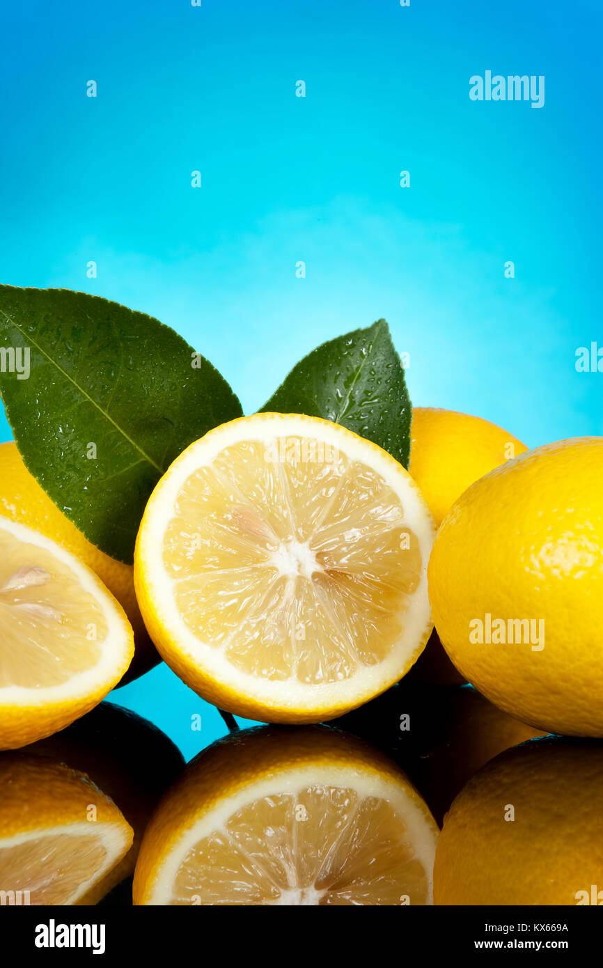 fresh cut lemon with green leaves Stock Photo - Alamy