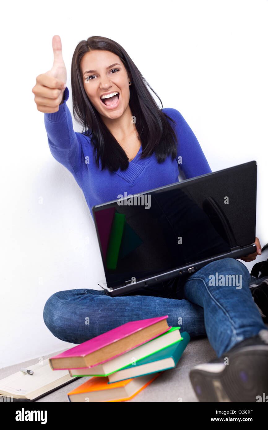 excited student girl with laptop showing thumb up Stock Photo - Alamy