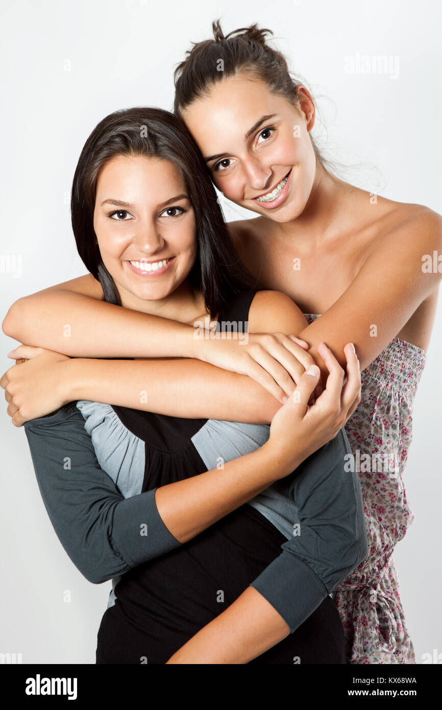 two young women or sisters hugging and smiling Stock Photo - Alamy