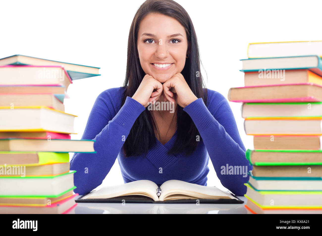 cheerful student girl between two stack of colorful books, isolated ...