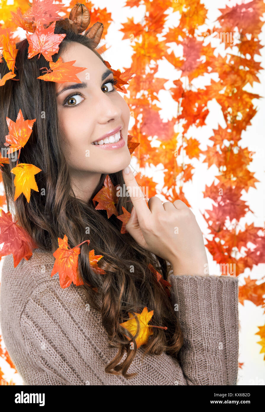 beautiful woman with orange leaves around her Stock Photo - Alamy