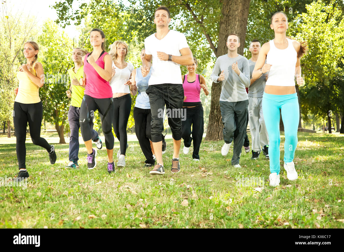 large group of young people running in nature Stock Photo - Alamy