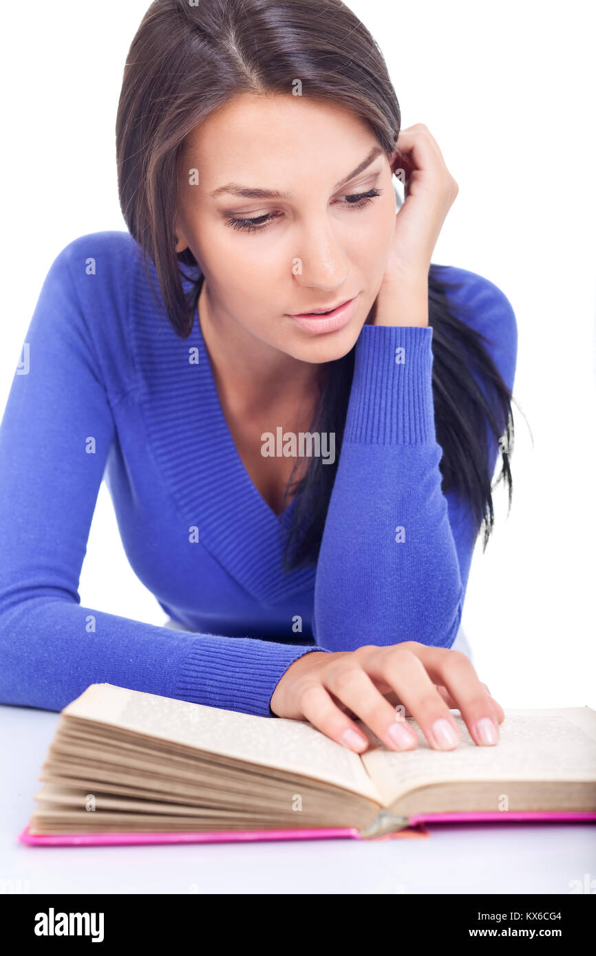 young girl focused on a reading a book, isolated on white background ...