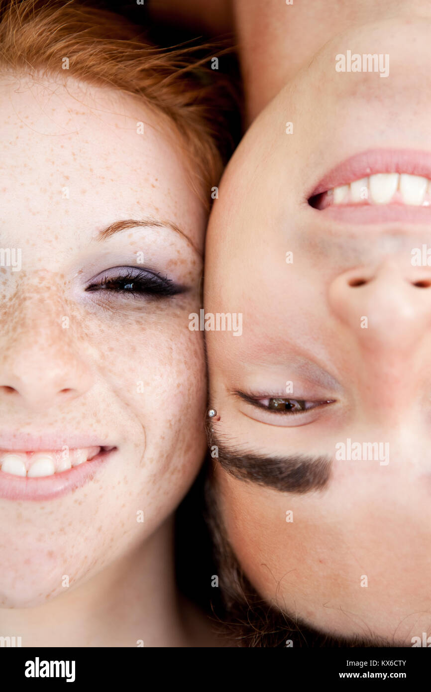 half of smiling faces, young couple top view Stock Photo - Alamy