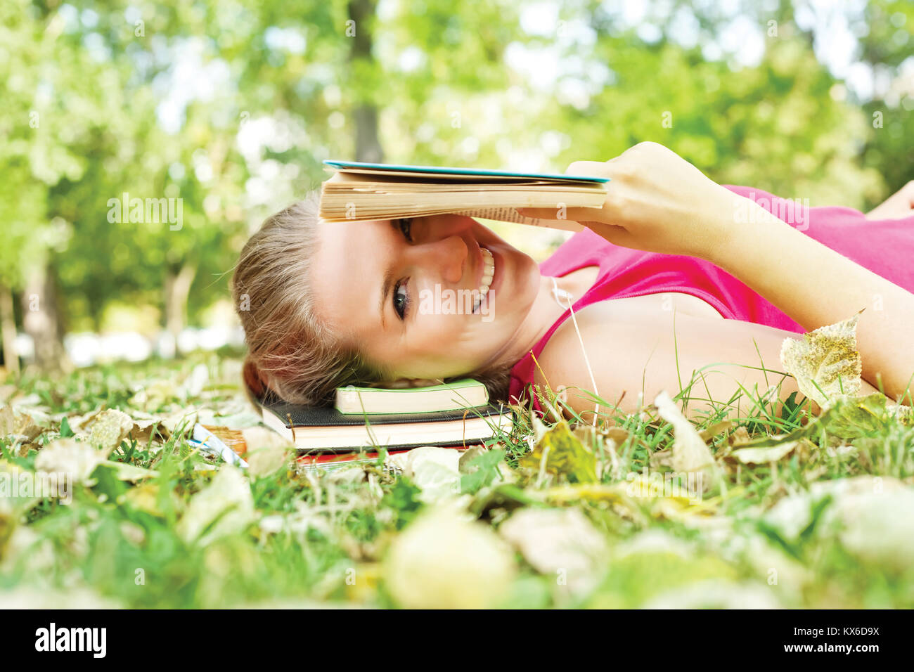 smiling girl reading ridiculous book Stock Photo - Alamy