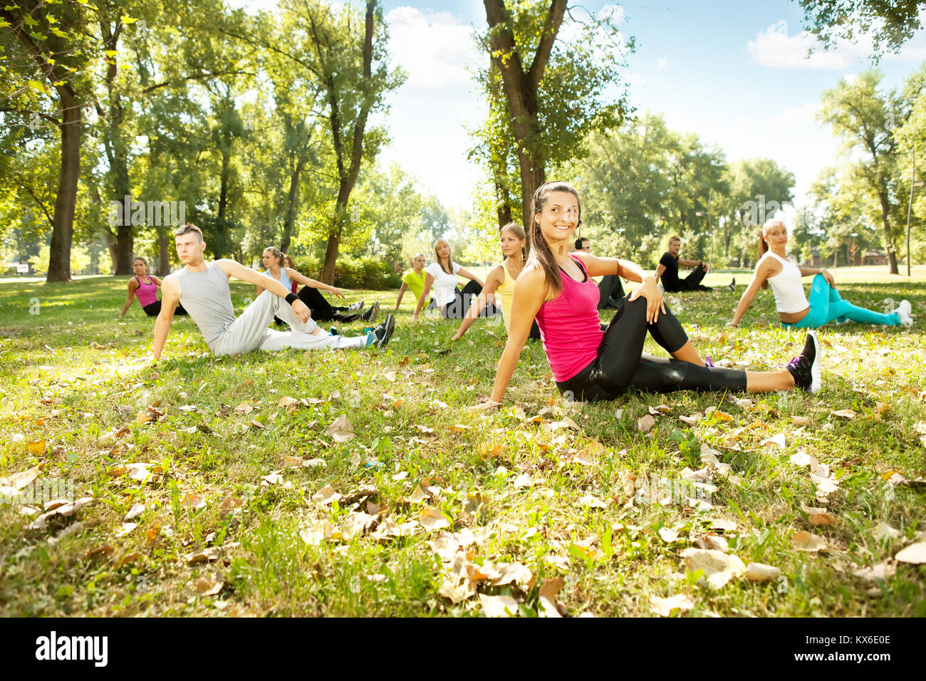 fitness class exercising in park Stock Photo - Alamy
