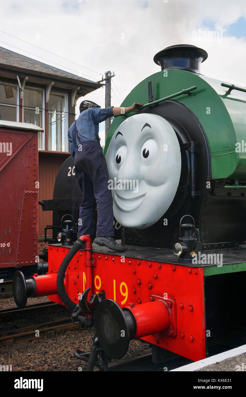 Railway workers on a green steam engine as part of a Thomas and Friends ...