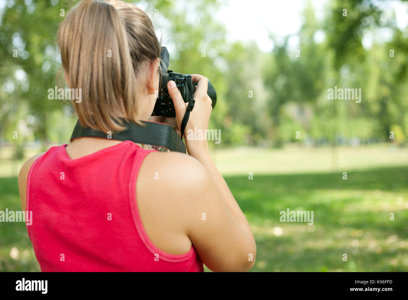 young girl taking picture on natural Stock Photo - Alamy